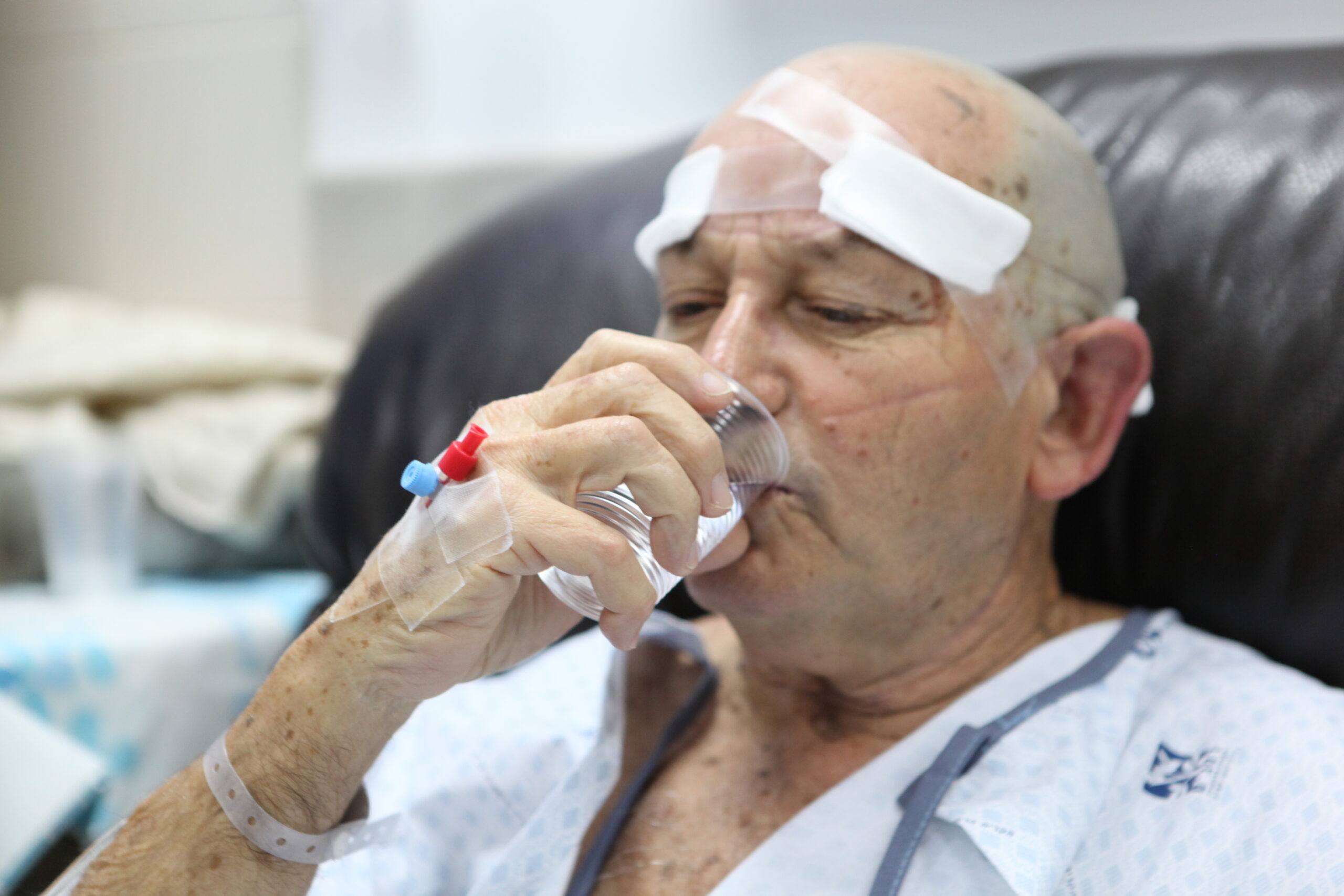 A patient easily drinking a cup of water after a successful procedure ...